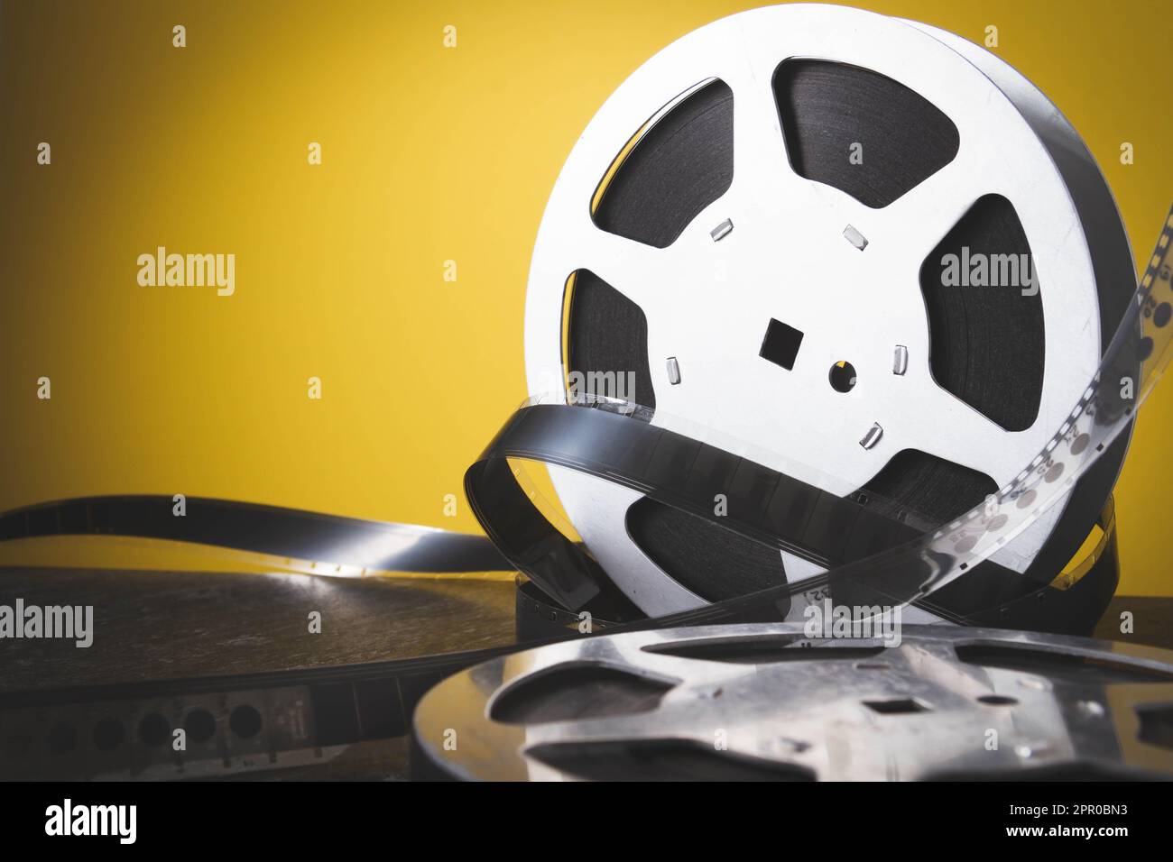 Old film. Cinema on reel. Analog cinema. Movie on cassette. Yellow ...