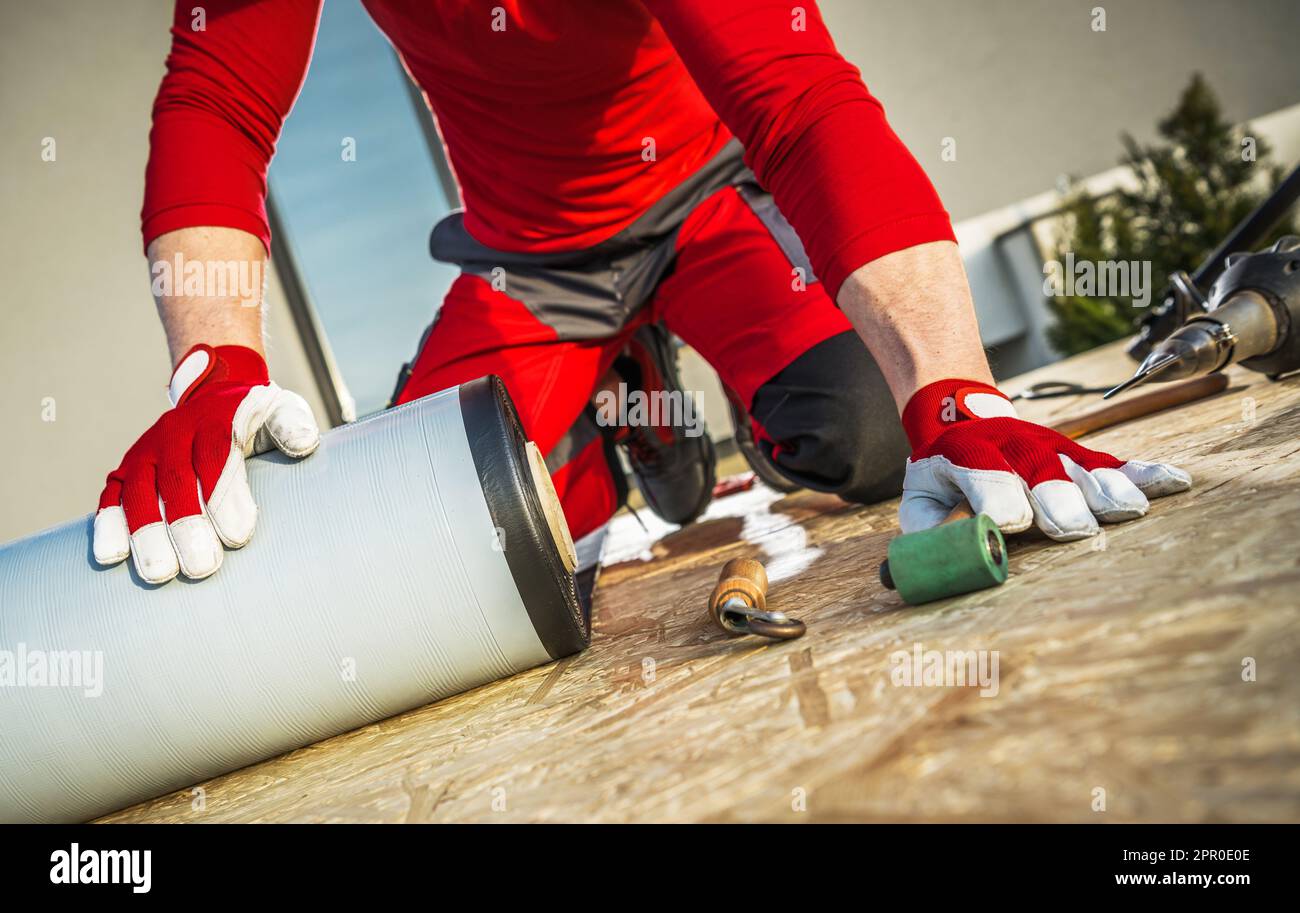 Roofing Worker with Roll of EPDM Rubber Material to Cover Wooden ...