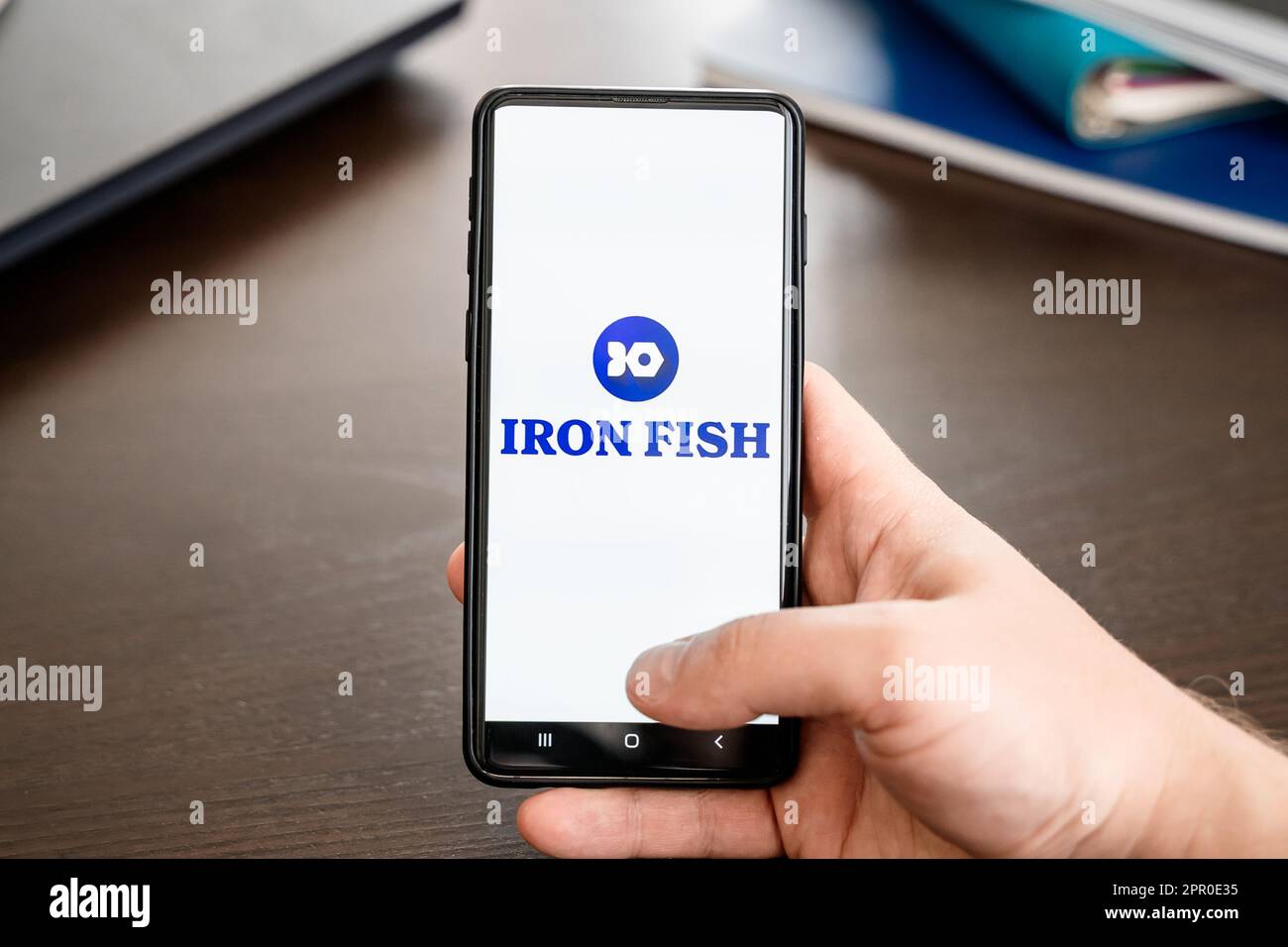 Russia Moscow 25.04.23 Logo of Iron Fish mining coin in mobile phone ...