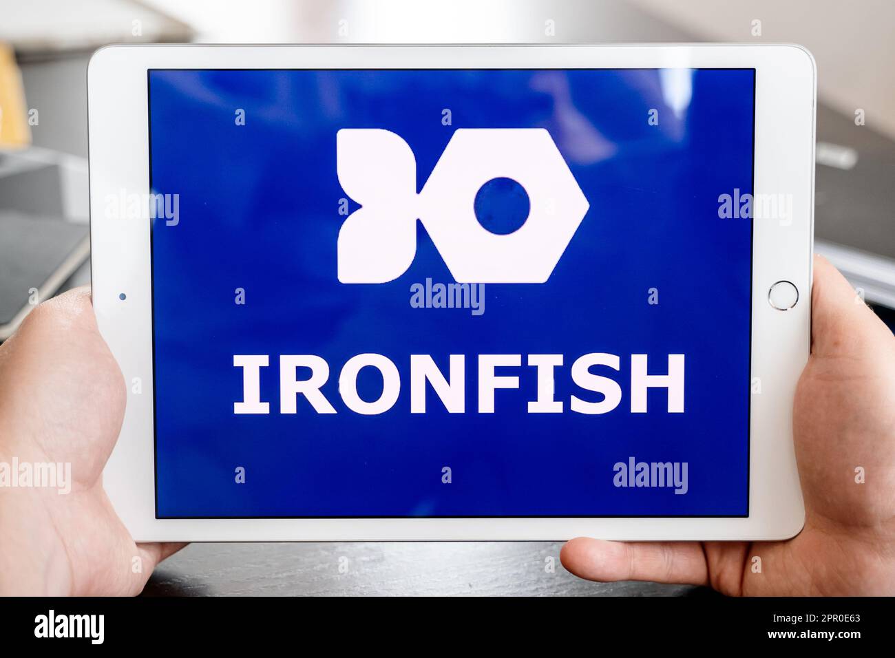 Russia Moscow 25.04.23 Logo of Iron Fish mining coin in tablen screen ...