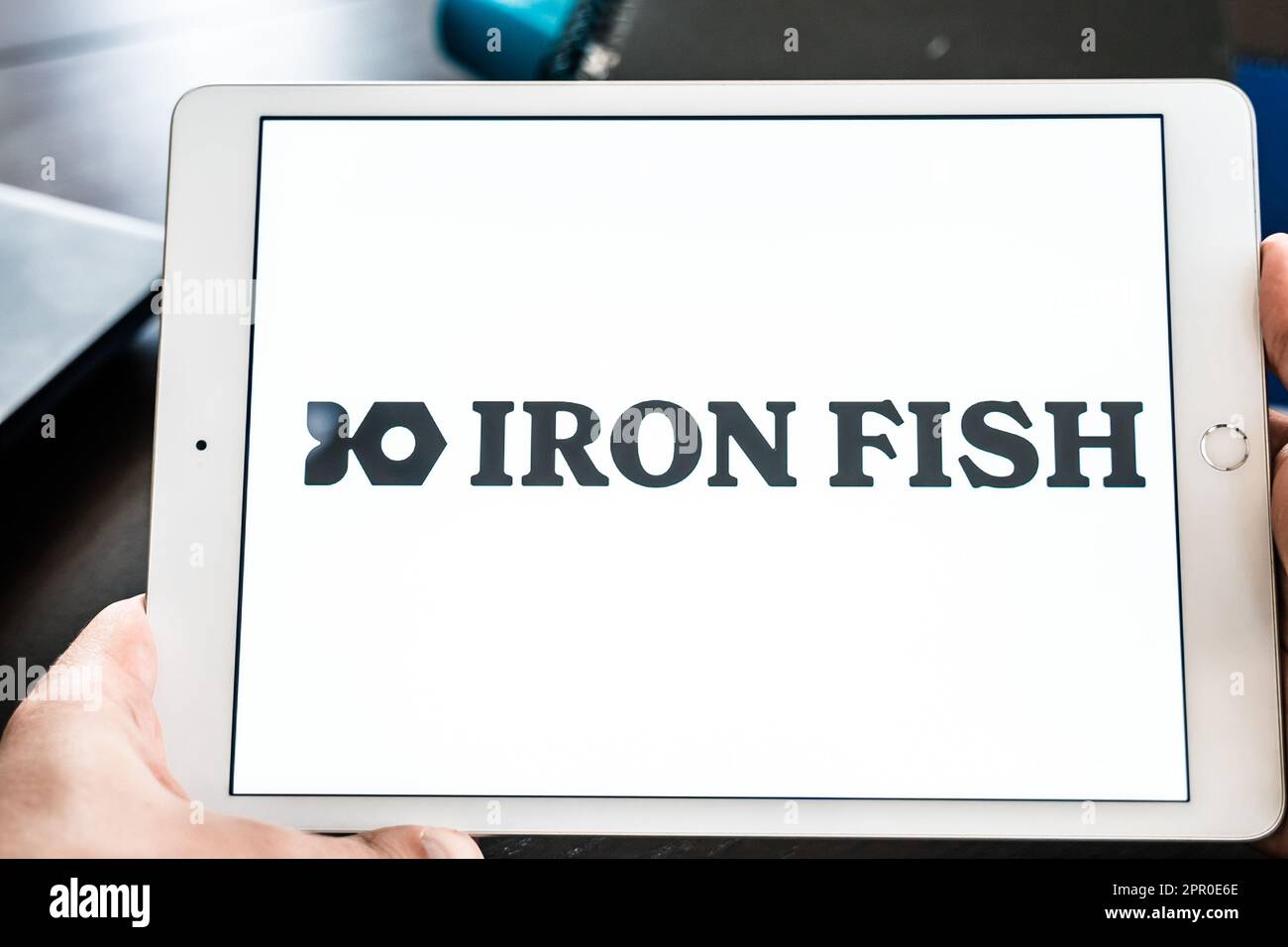 Russia Moscow 25.04.23 Logo of Iron Fish mining coin in tablen screen ...