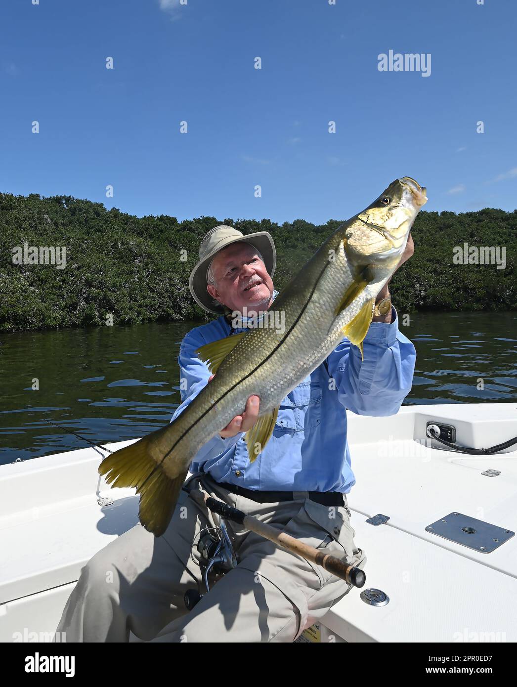 An angler admires a nice catch from the flats and islands off Crystal ...