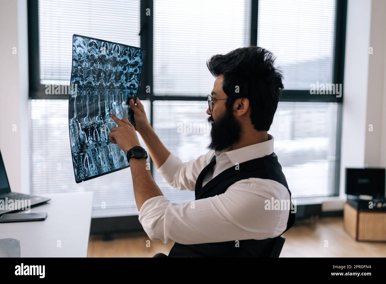 Side view of professional Indian male doctor thinking on diagnosis ...