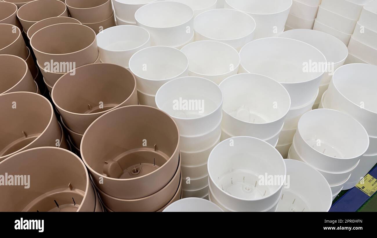 Close-up of empty flower pots in a store or greenhouse. Colorful pots ...