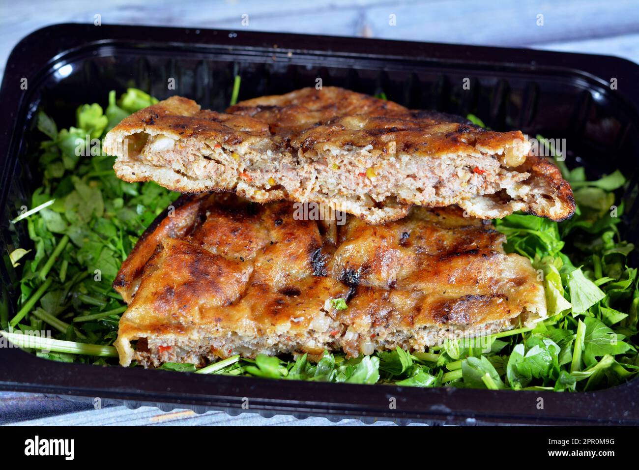 Traditional Egyptian dish Hawawshi, pita stuffed with minced meat and ...