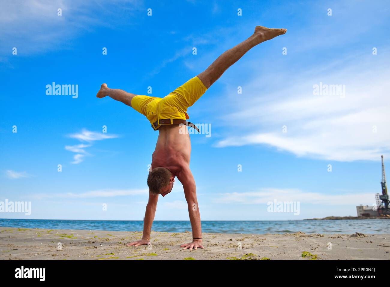yoga man standing on hands and does the splits Stock Photo - Alamy