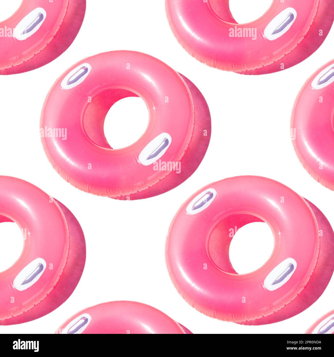 Bright pink inflatable circle with white handles and a shadow on a ...