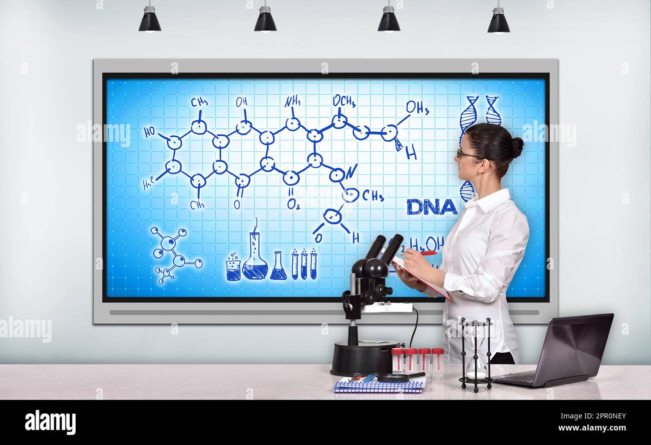 woman scientific researcher in laboratory and looking on plasma panel ...