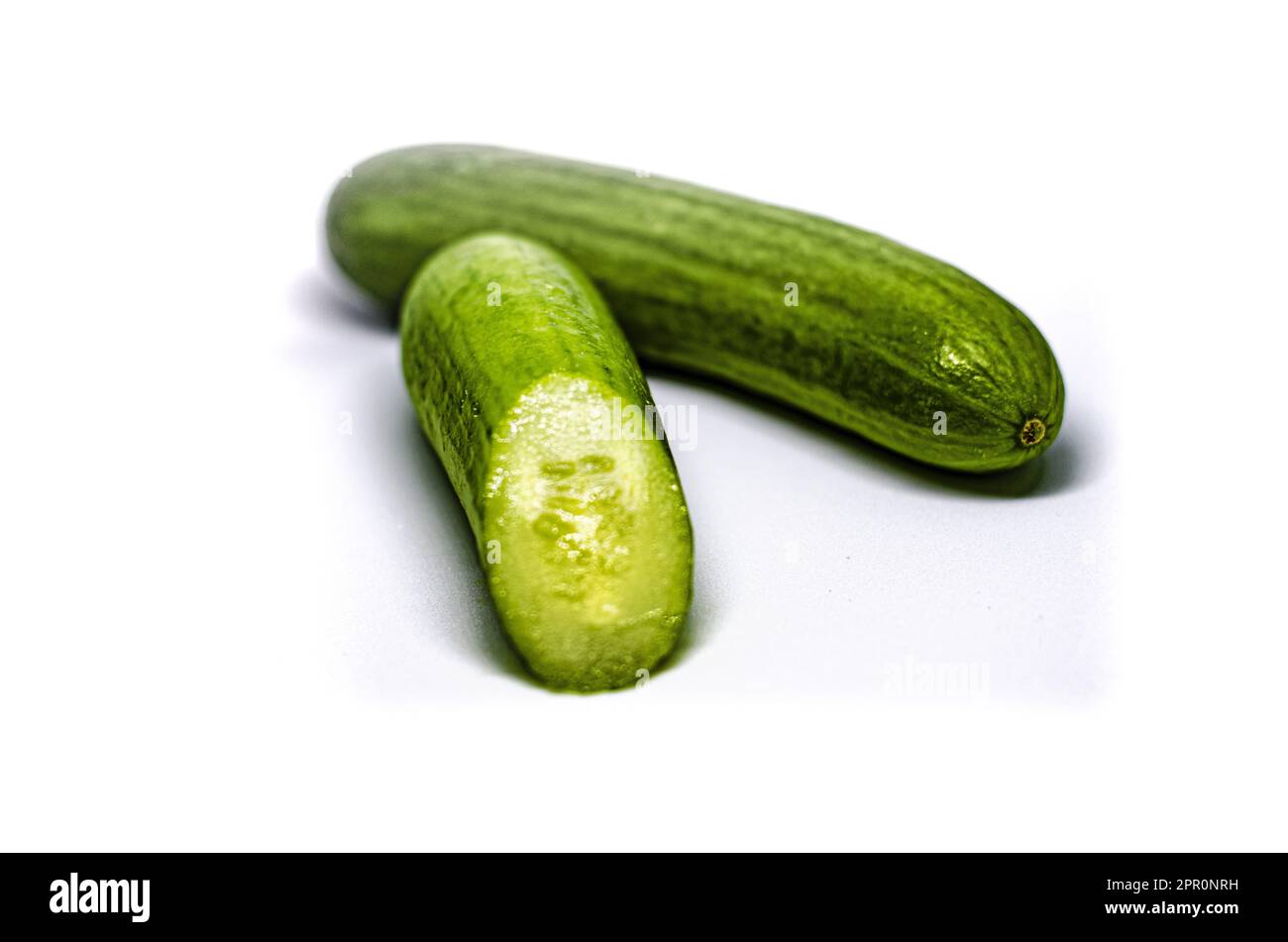 Fresh Whole and Half Cucumbers on White Background, Close-Up Stock ...