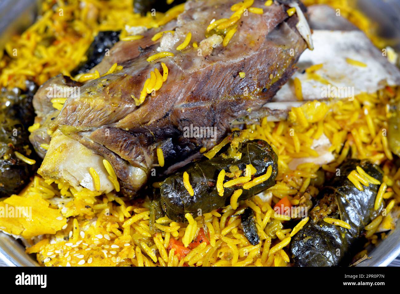 A well cooked lamb shank with yellow Basmati rice and mixed vegetables ...