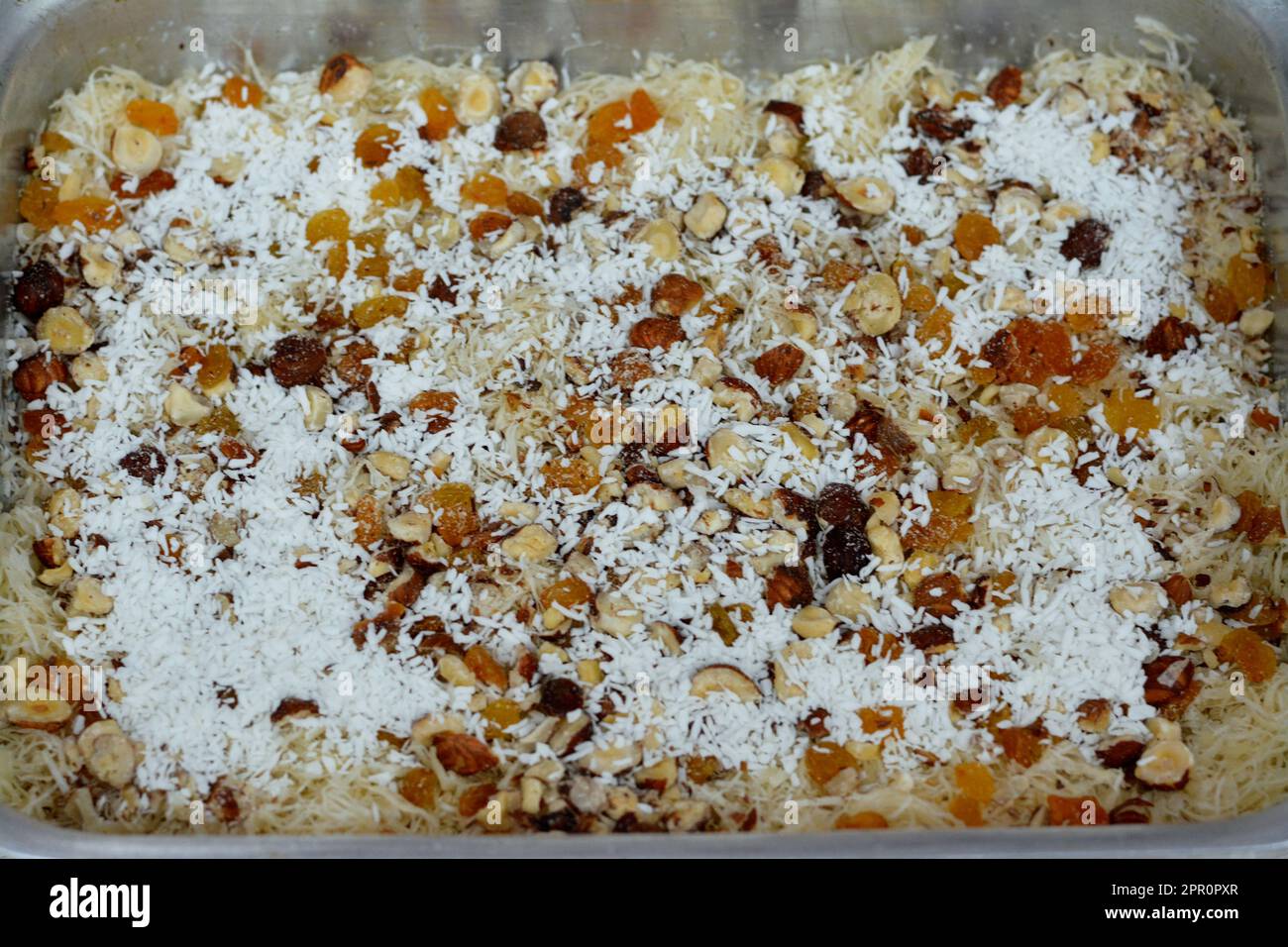 A traditional middle eastern dessert Knafeh made with spun pastry ...