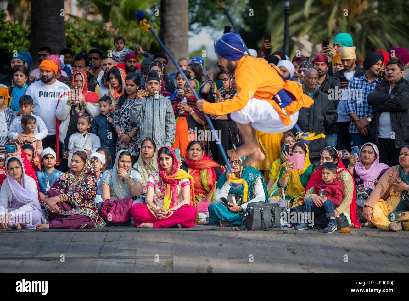 Sikh men and women watch the performance during the procession for the ...