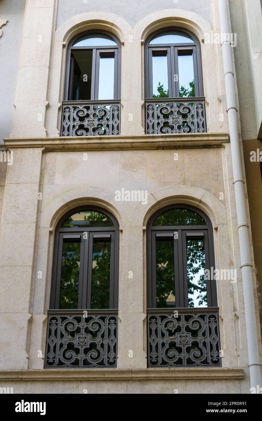 Beautiful modern european stone clad facade with high arched windows ...