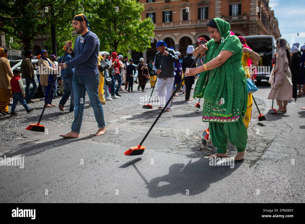 Sevadar (volunteers) clean the street during the procession for the ...