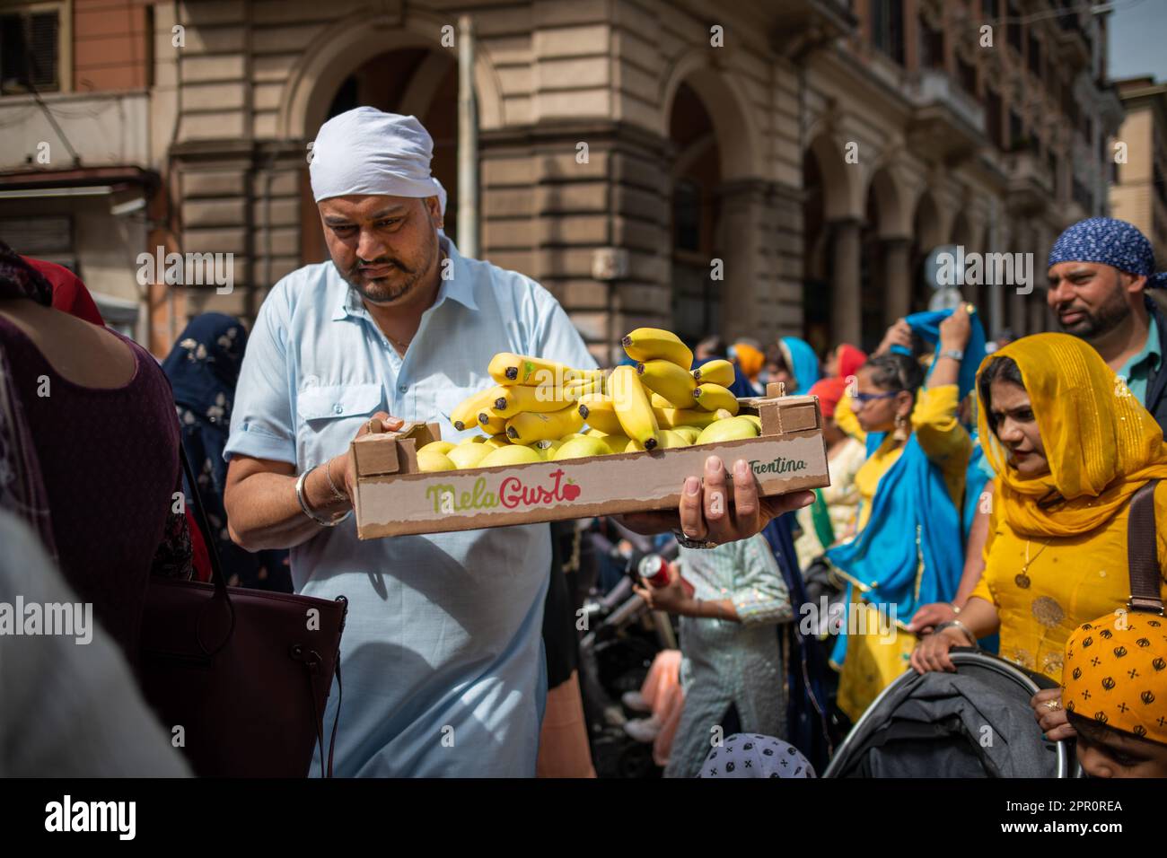 Sevadar (volunteer) distributes food during the procession for the ...