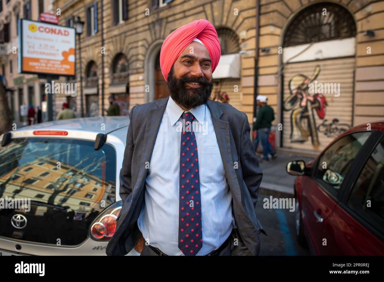 A Sikh in a smart suit and tie with a turban looks on during the ...