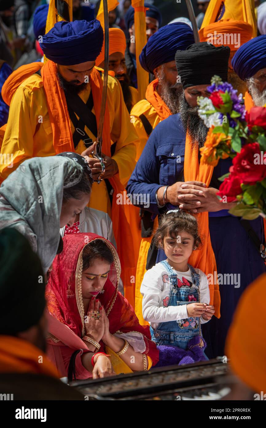 Sikh men and women pray during the procession for the Vaisakhi Nagar ...