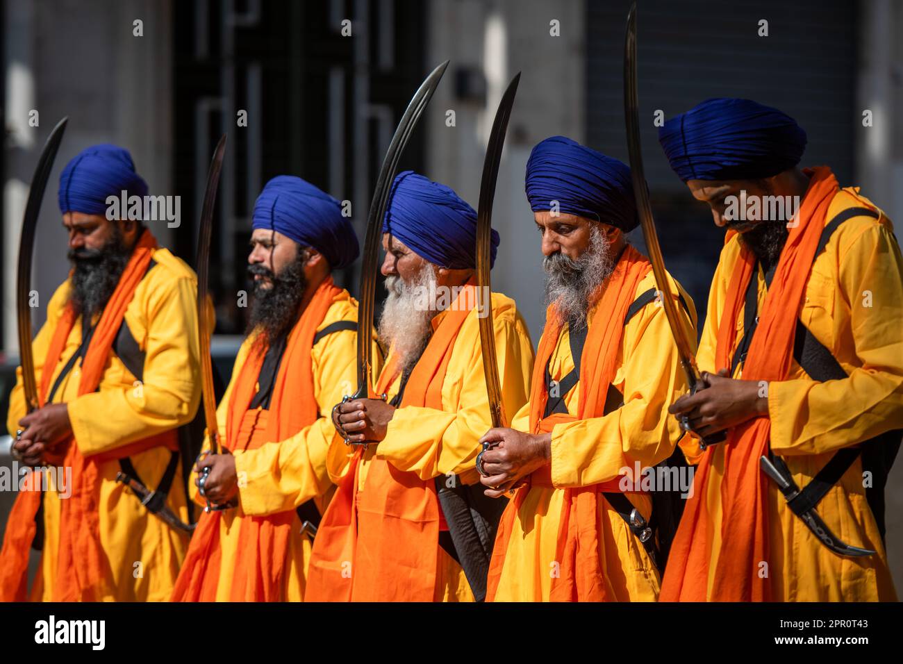 Sikh men with the kirpan, escort the Granth Sahib during the procession ...