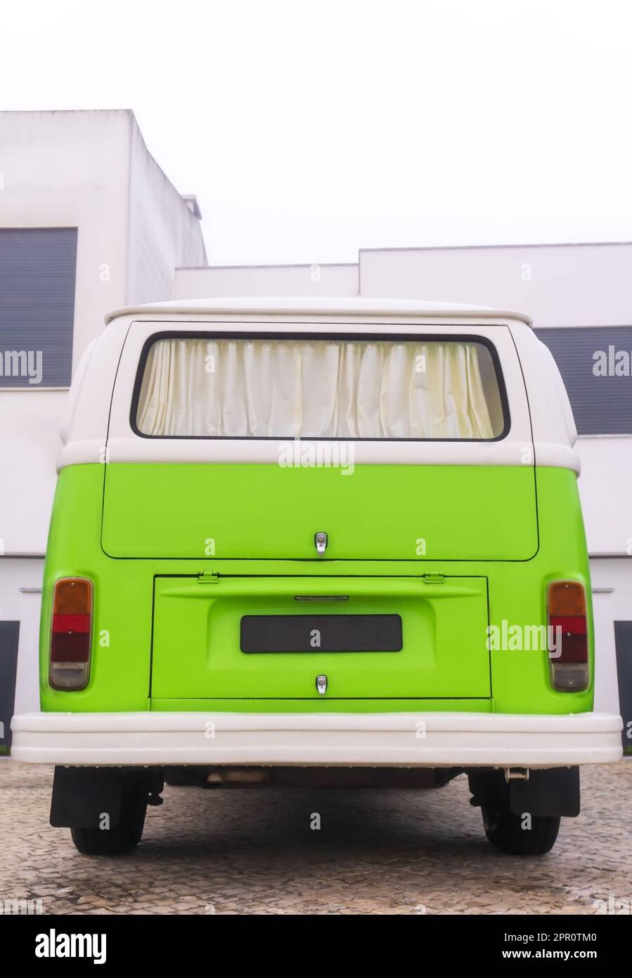 Back view of a bright white and green retro Volkswagen van close up ...