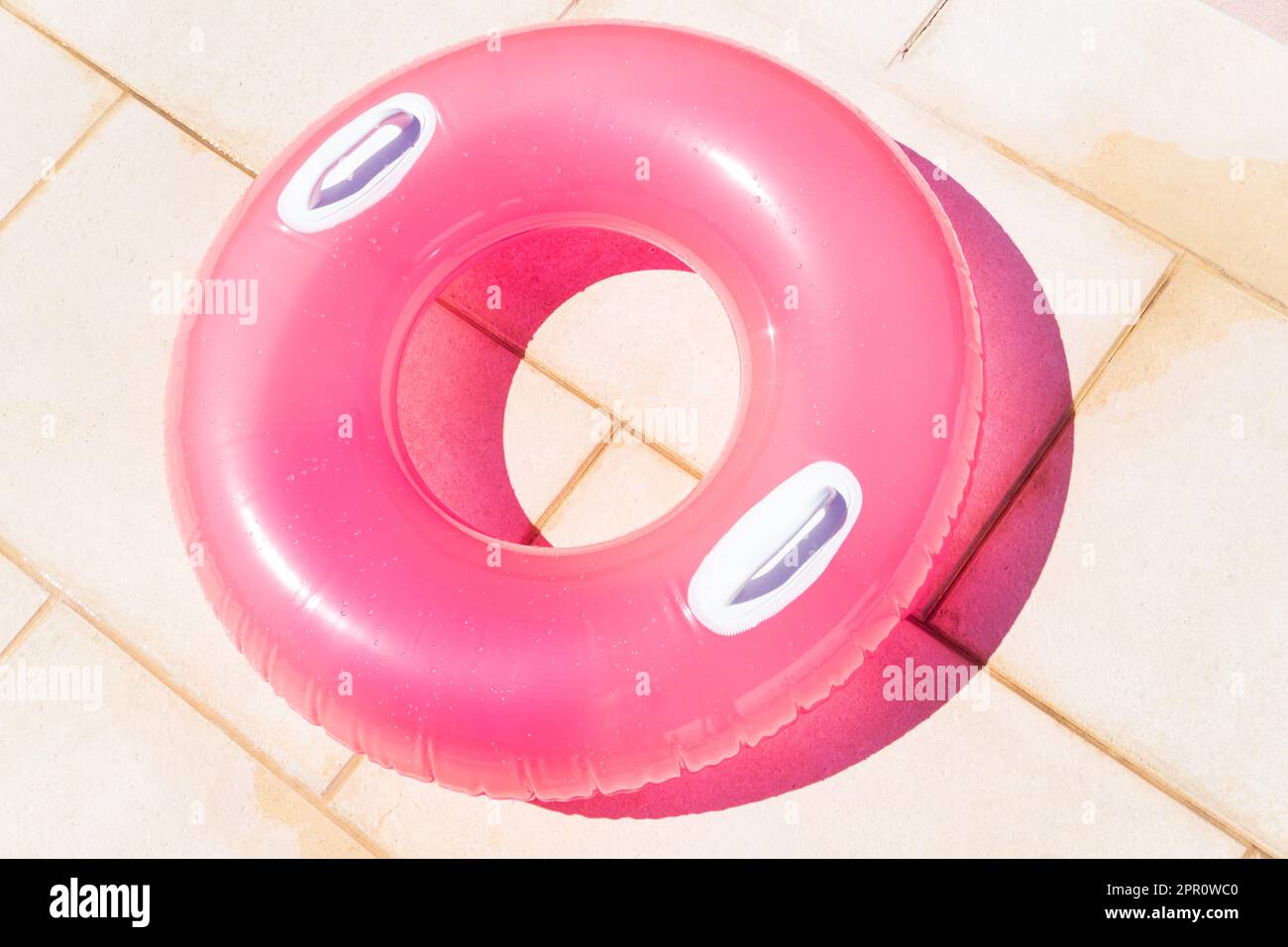 Translucent pink swim ring under the bright sun background Stock Photo ...