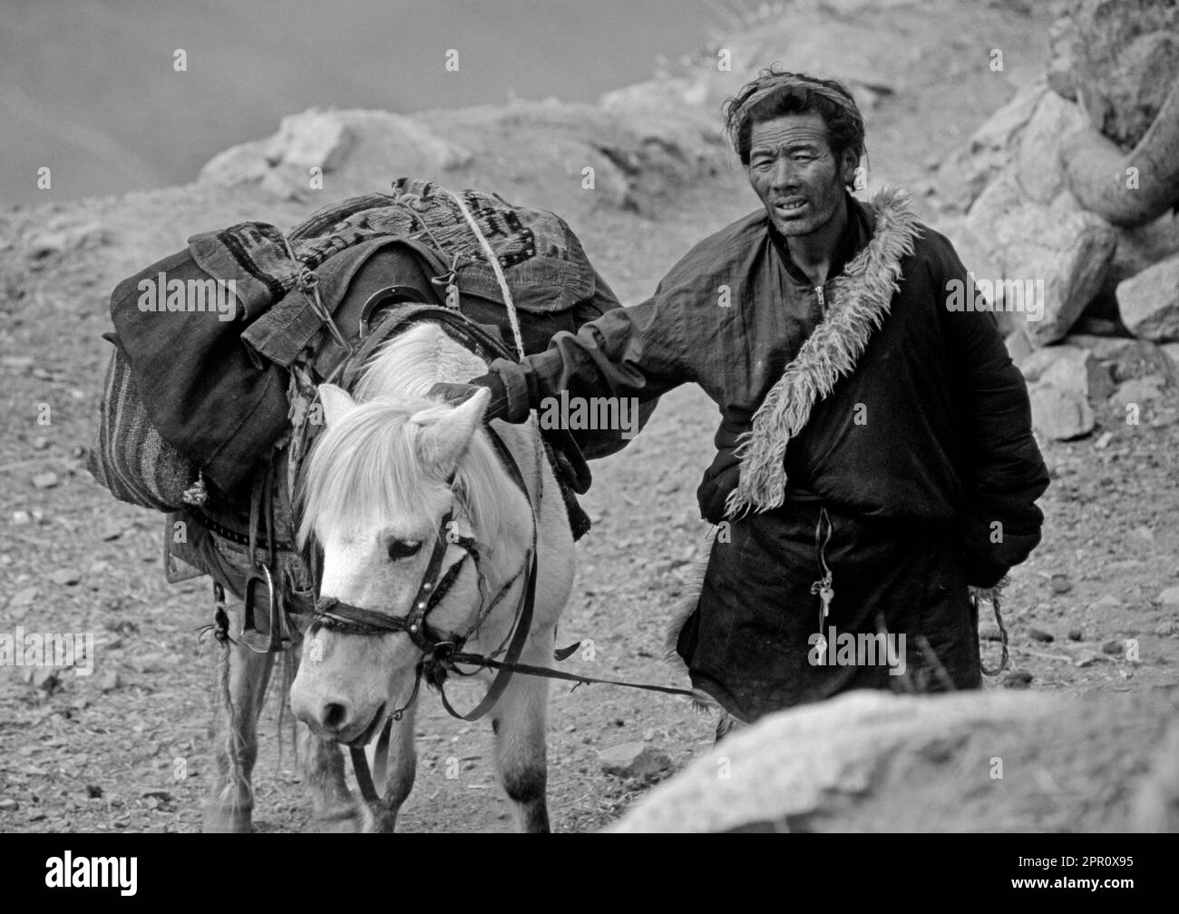 TIBETAN MAN with traditionally saddled horse at the DRIGUNG MONASTERY ...