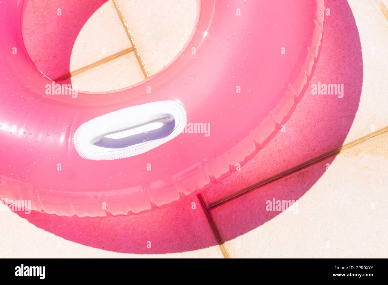 Translucent pink swim ring under the bright sun background Stock Photo ...