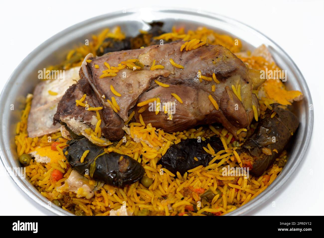 A well cooked lamb shank with yellow Basmati rice and mixed vegetables ...