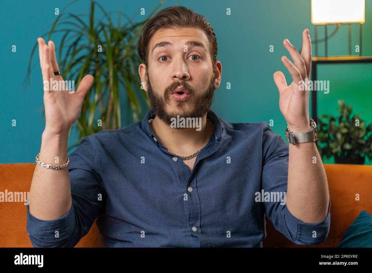 Oh my God, Wow. Young lebanese man surprised looking at camera with big ...
