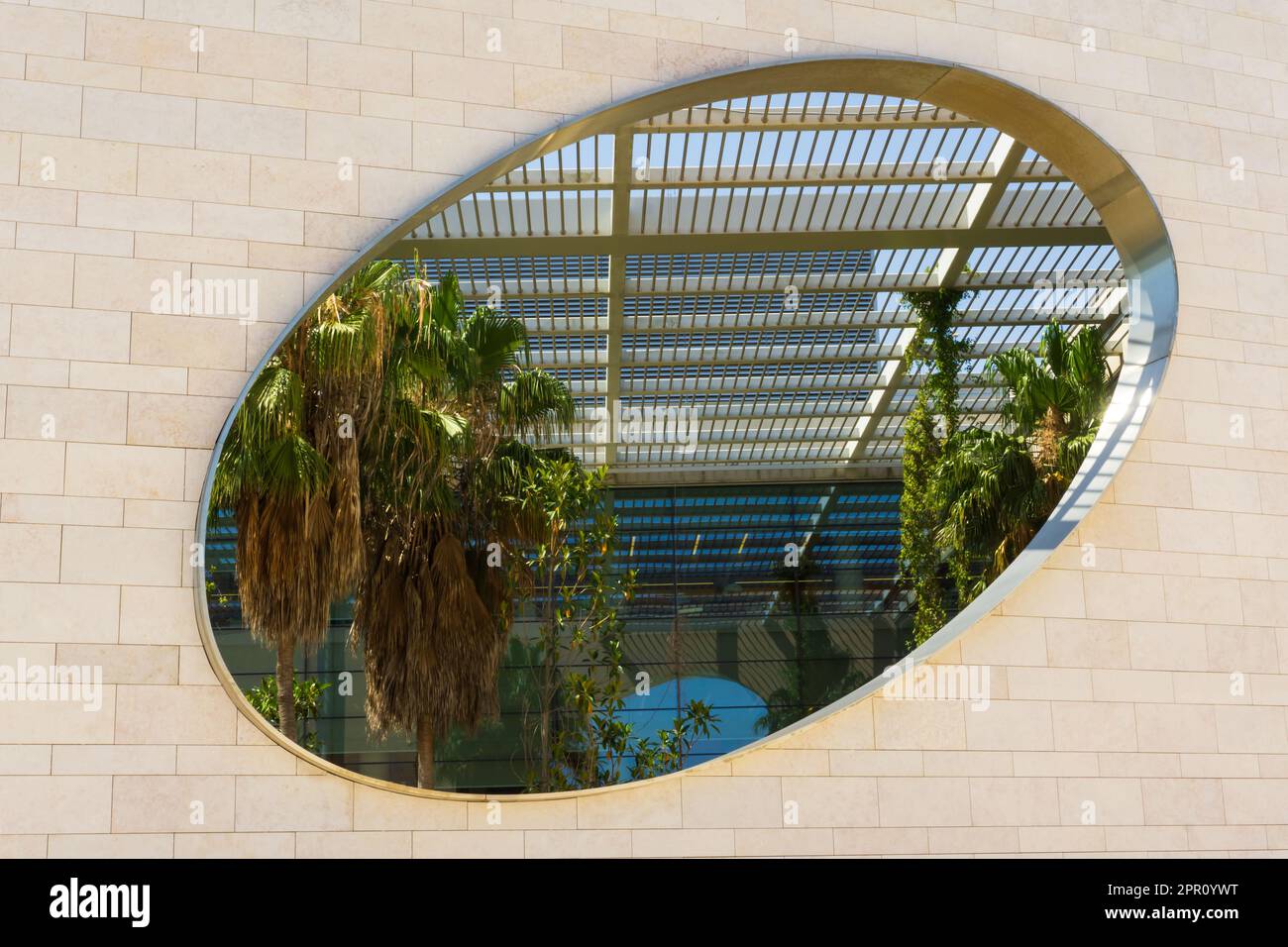 A modern building with tropical plants and palm trees inside Stock ...