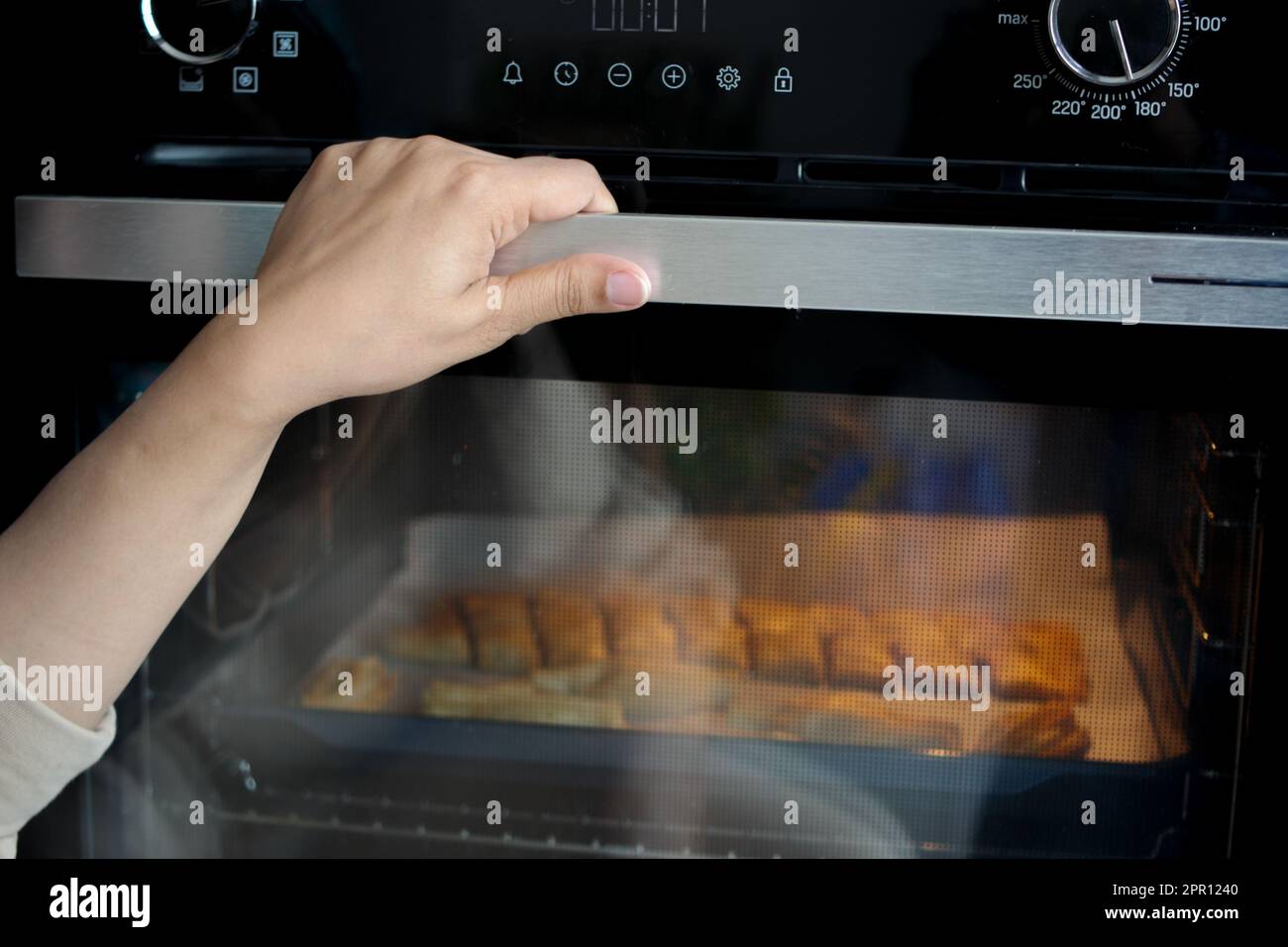 Hand checking stove hi-res stock photography and images - Alamy