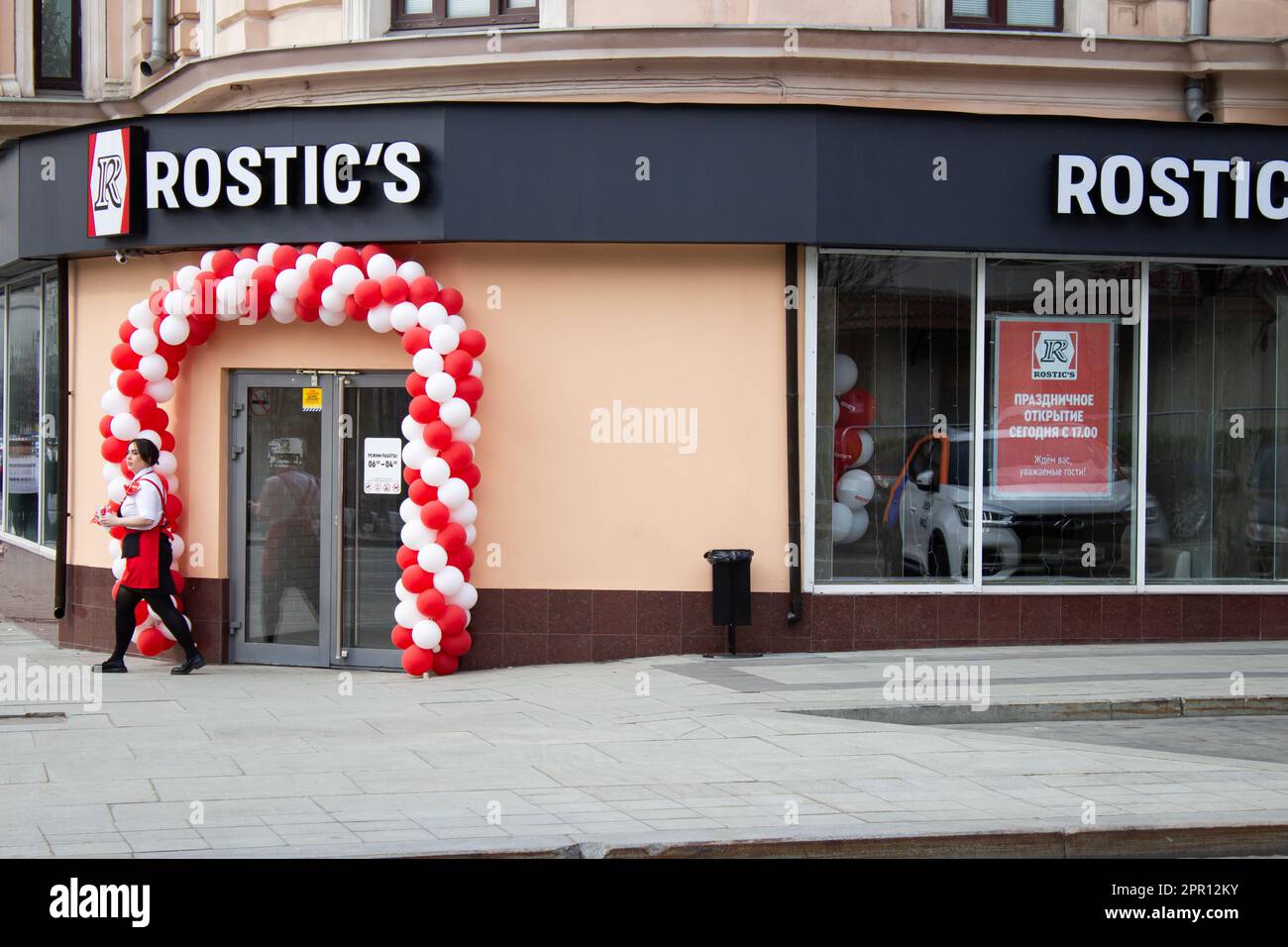 An employee of a new Rostic's restaurant walks by an entrance to a ...