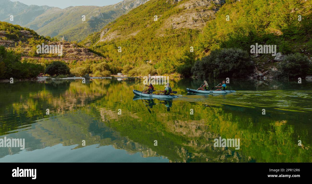 A group of friends enjoying having fun and kayaking while exploring the ...