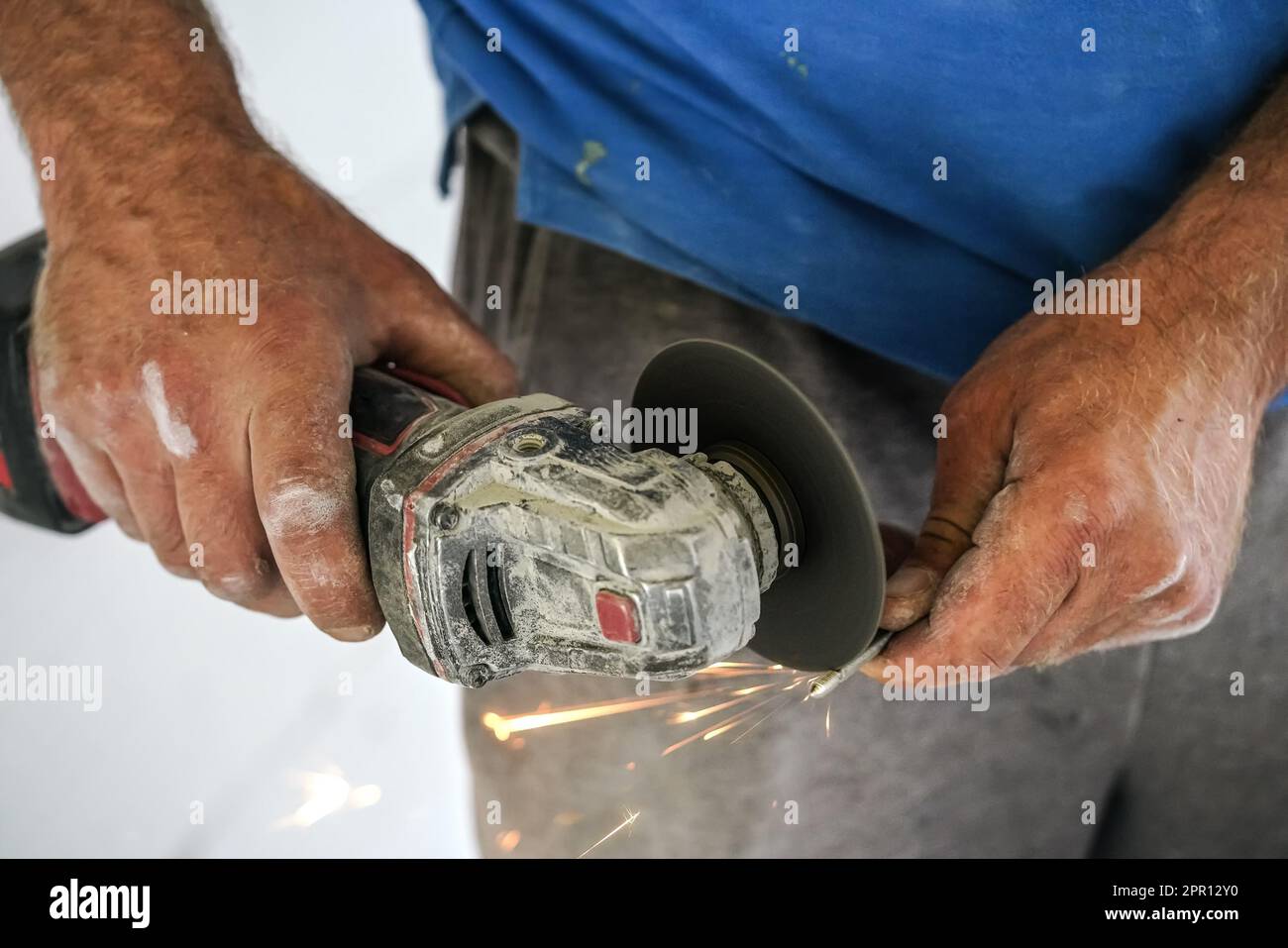 Shortening screw with old rotary cutter, sparks flying as metal is cut ...