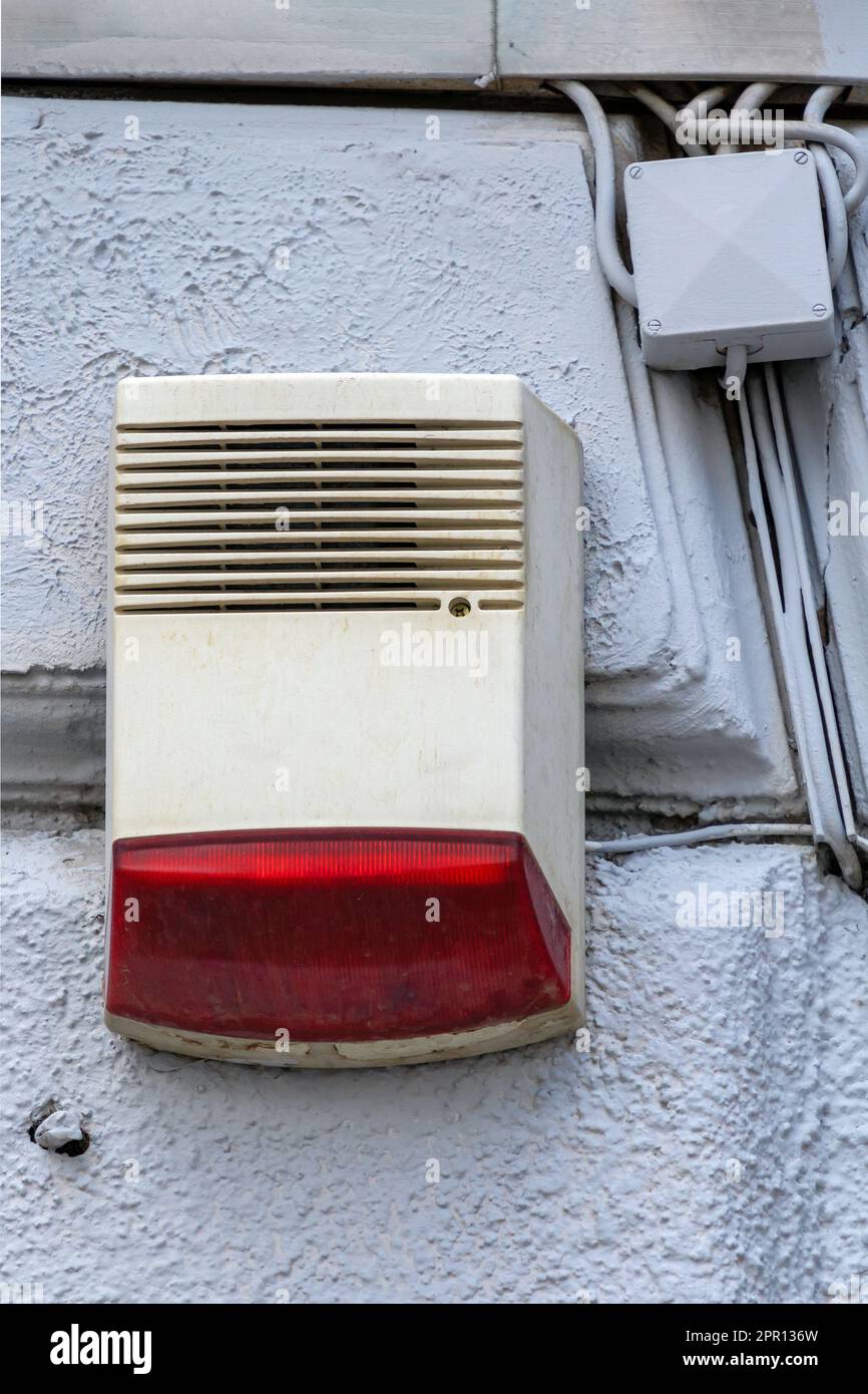 Alarm security unit attached to house facade outside wall Stock Photo ...