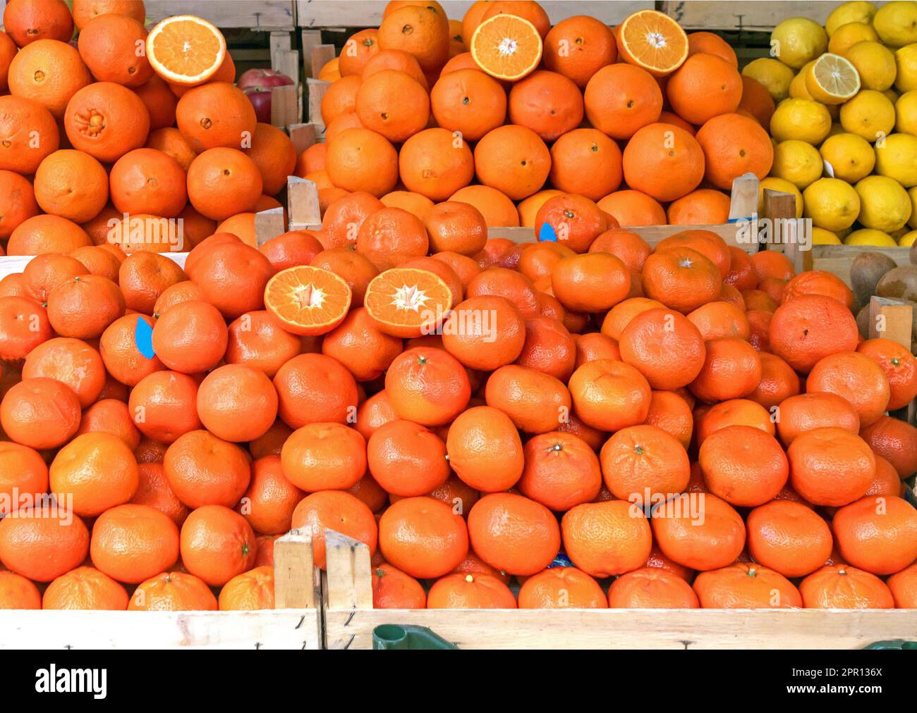 Large pile of oranges lemons and other citrus fruits in wooden crates ...