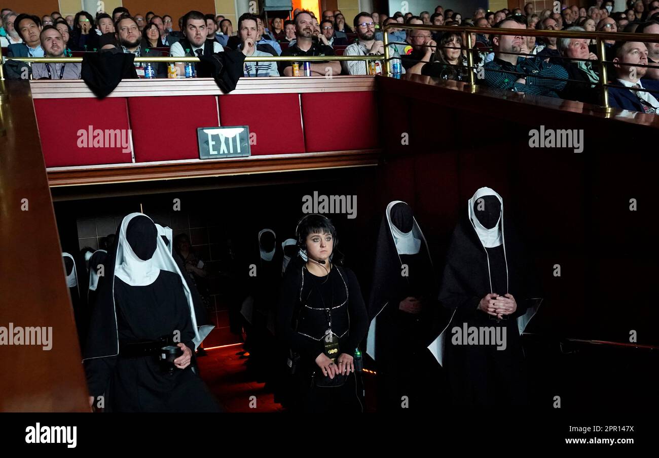 Performers dressed as nuns wait for their cue to enter before a trailer ...