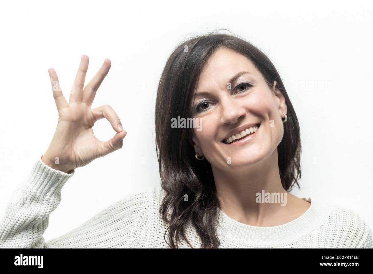 Positive Communication: Woman Giving OK Sign on White Background Stock ...