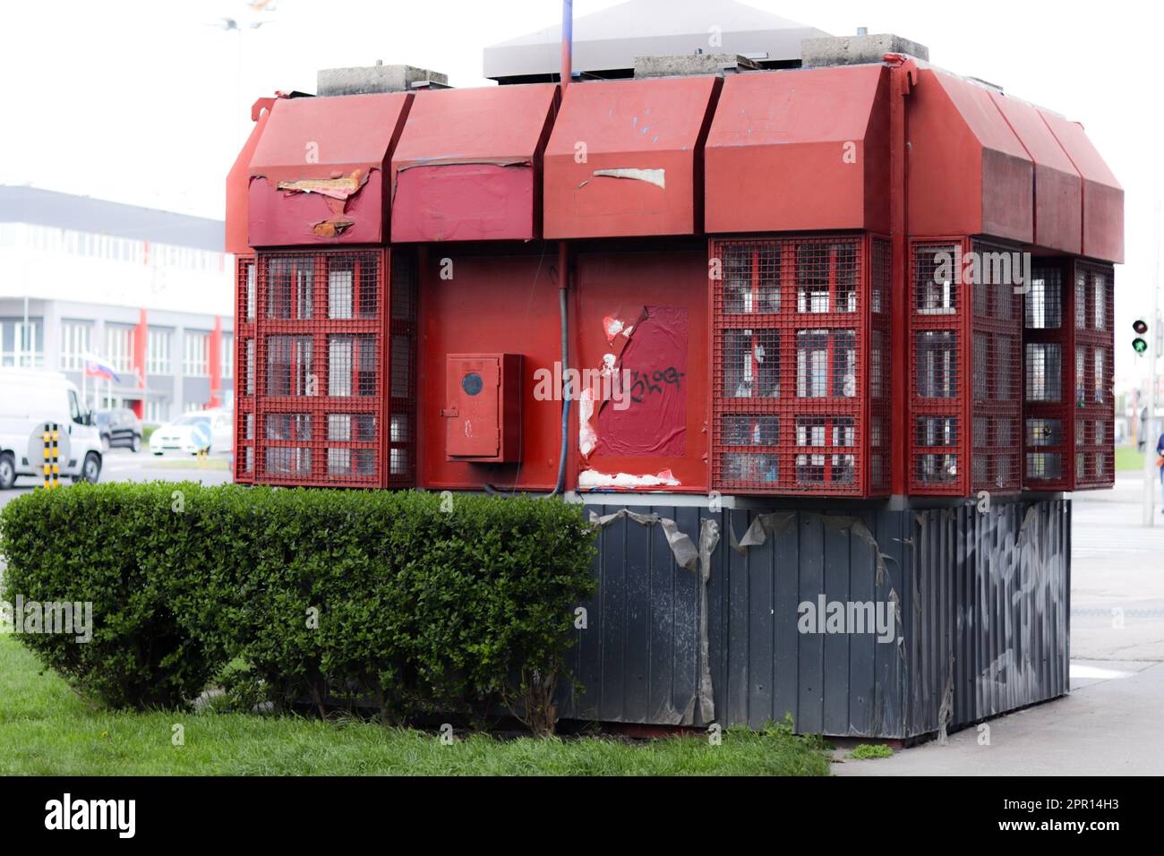small red building on a street with green grass Stock Photo - Alamy