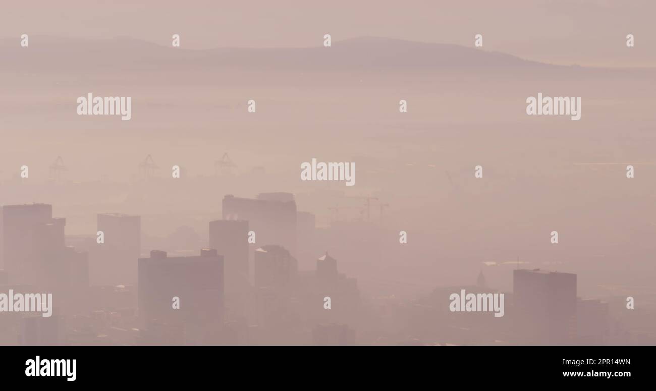 General view of foggy cityscape with modern buildings over landscape of ...