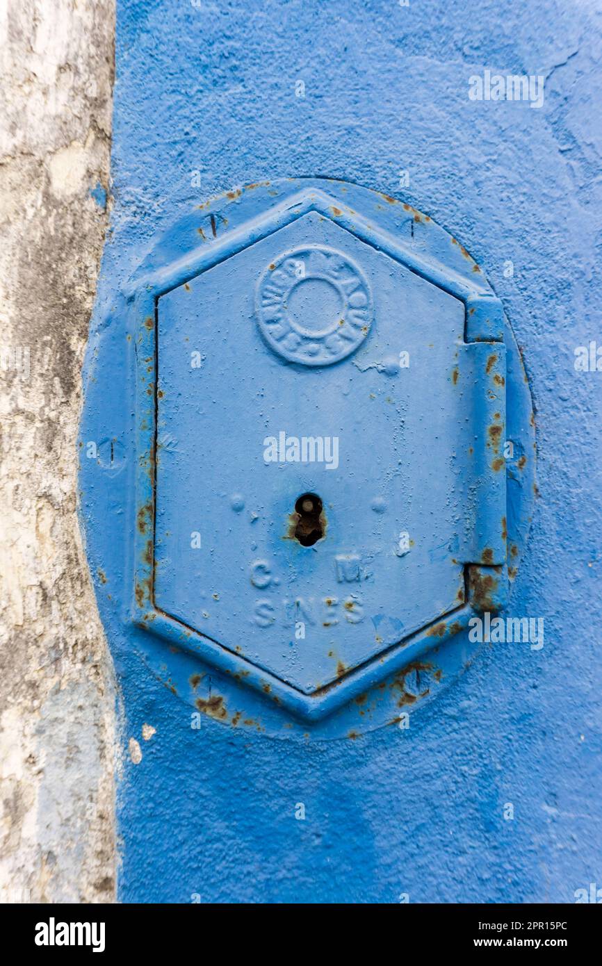 Old rusty blue painted iron lid of a valve box of the SERVICO DE AGUA ...