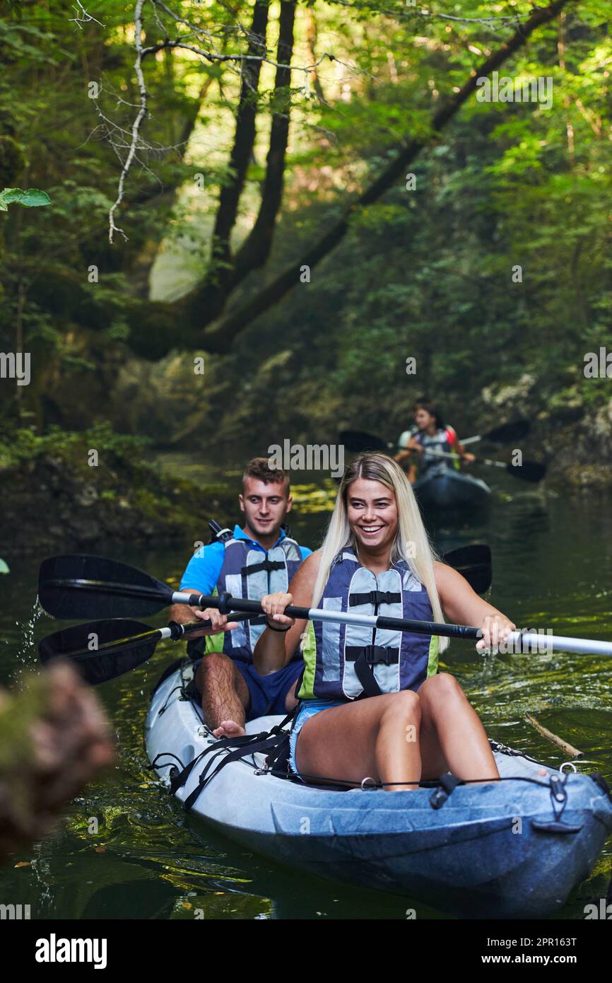 A group of friends enjoying having fun and kayaking while exploring the ...