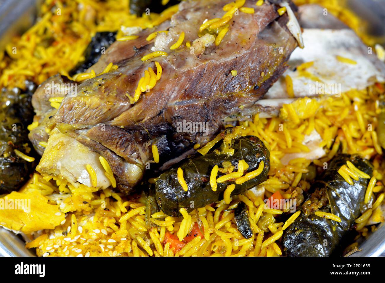A well cooked lamb shank with yellow Basmati rice and mixed vegetables ...
