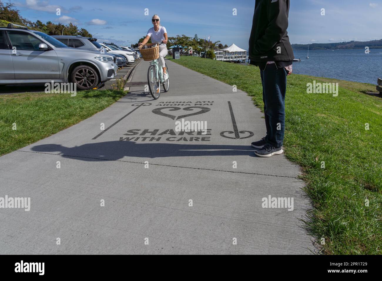 Taupo New Zealand - April 15 2023; woman cycles along path with share ...