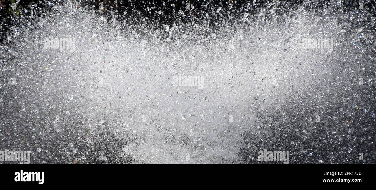 Background image shows closeup of a water feature. Water is spraying ...