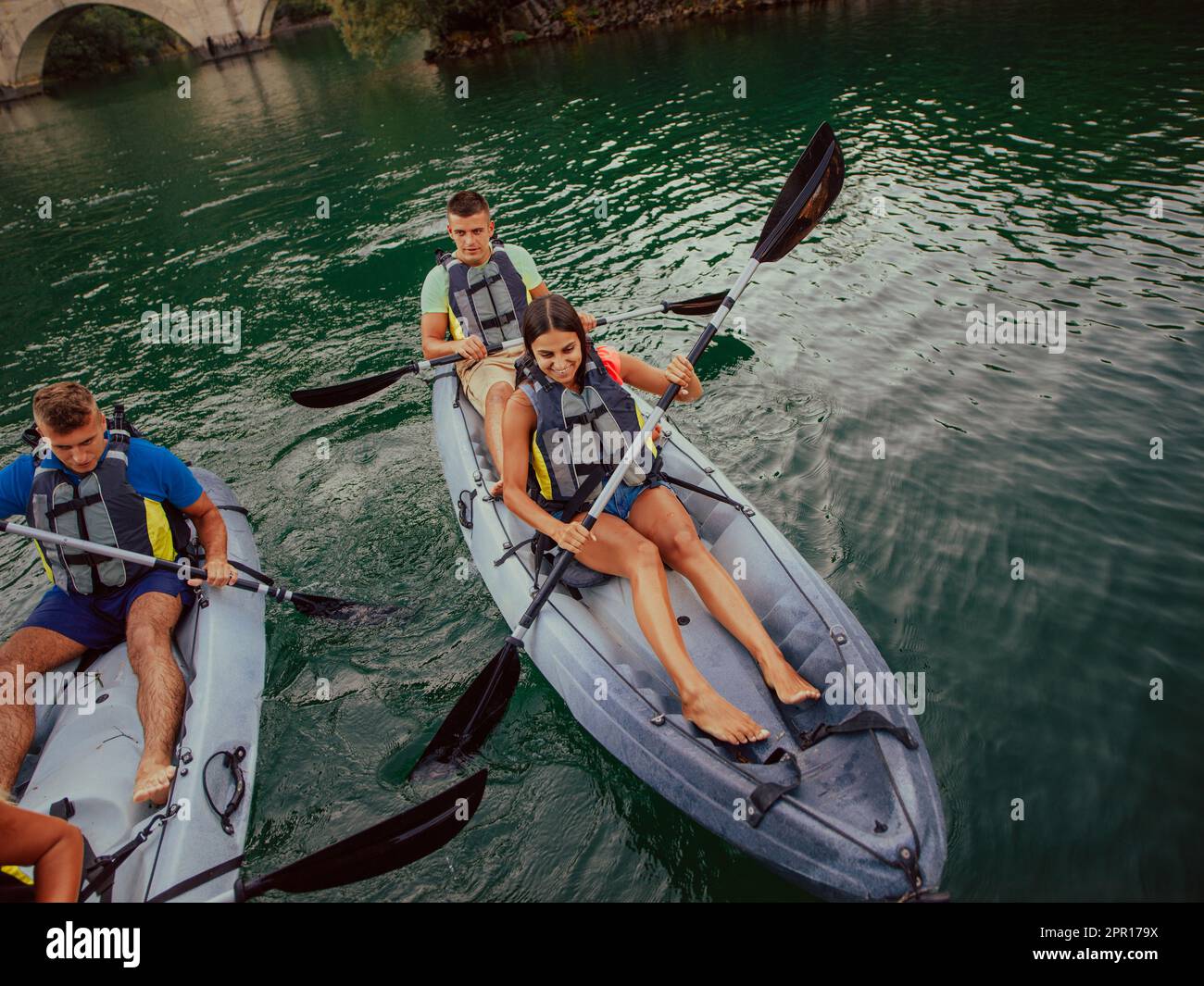 A group of friends enjoying having fun and kayaking while exploring the ...