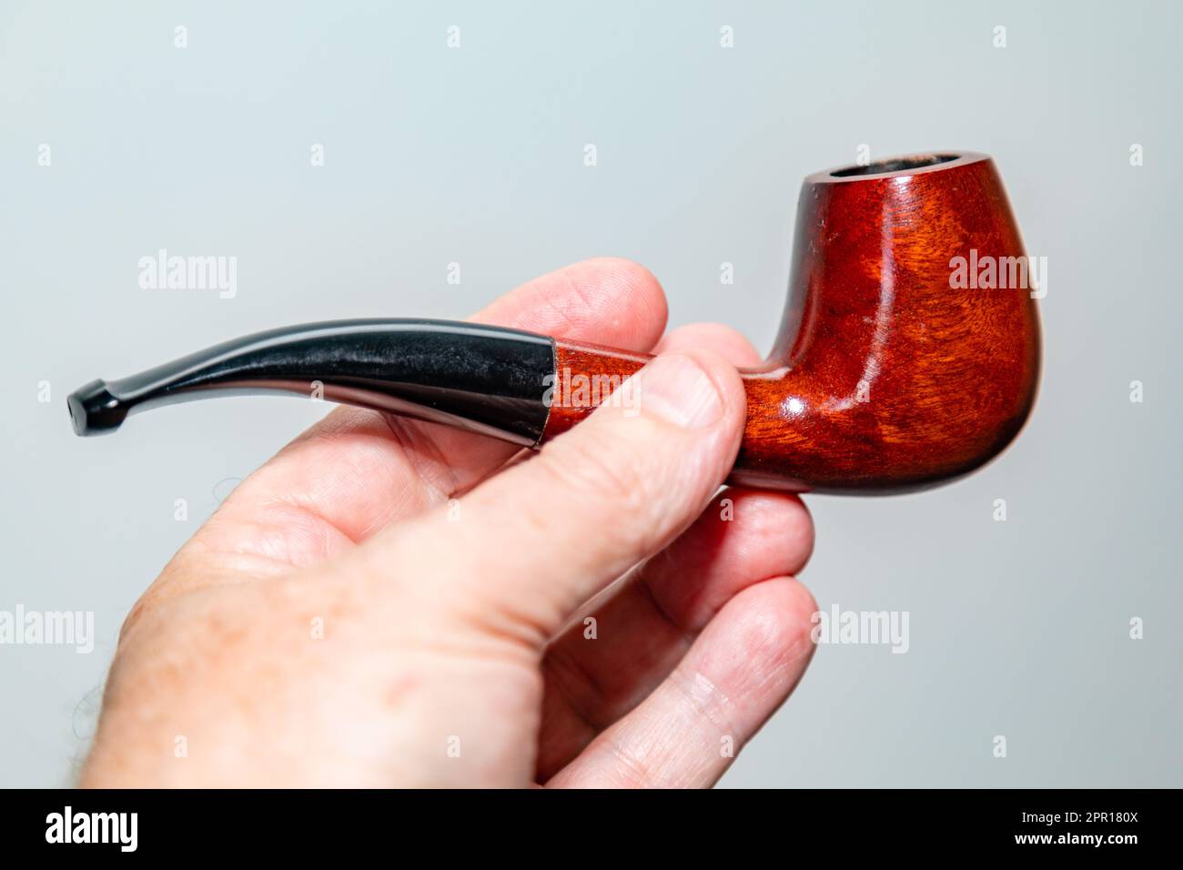 Traditional pipe isolated on light background Stock Photo - Alamy