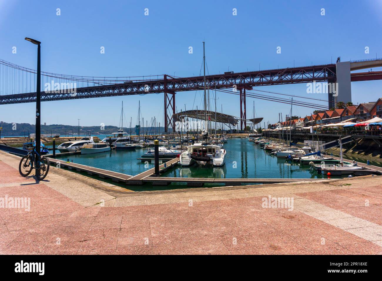Berth with yachts under the Lisbon bridge April 25 Stock Photo - Alamy