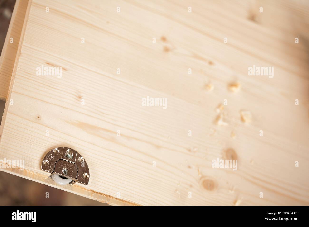 Metal detail inserted into a wooden component that will form a piece of ...