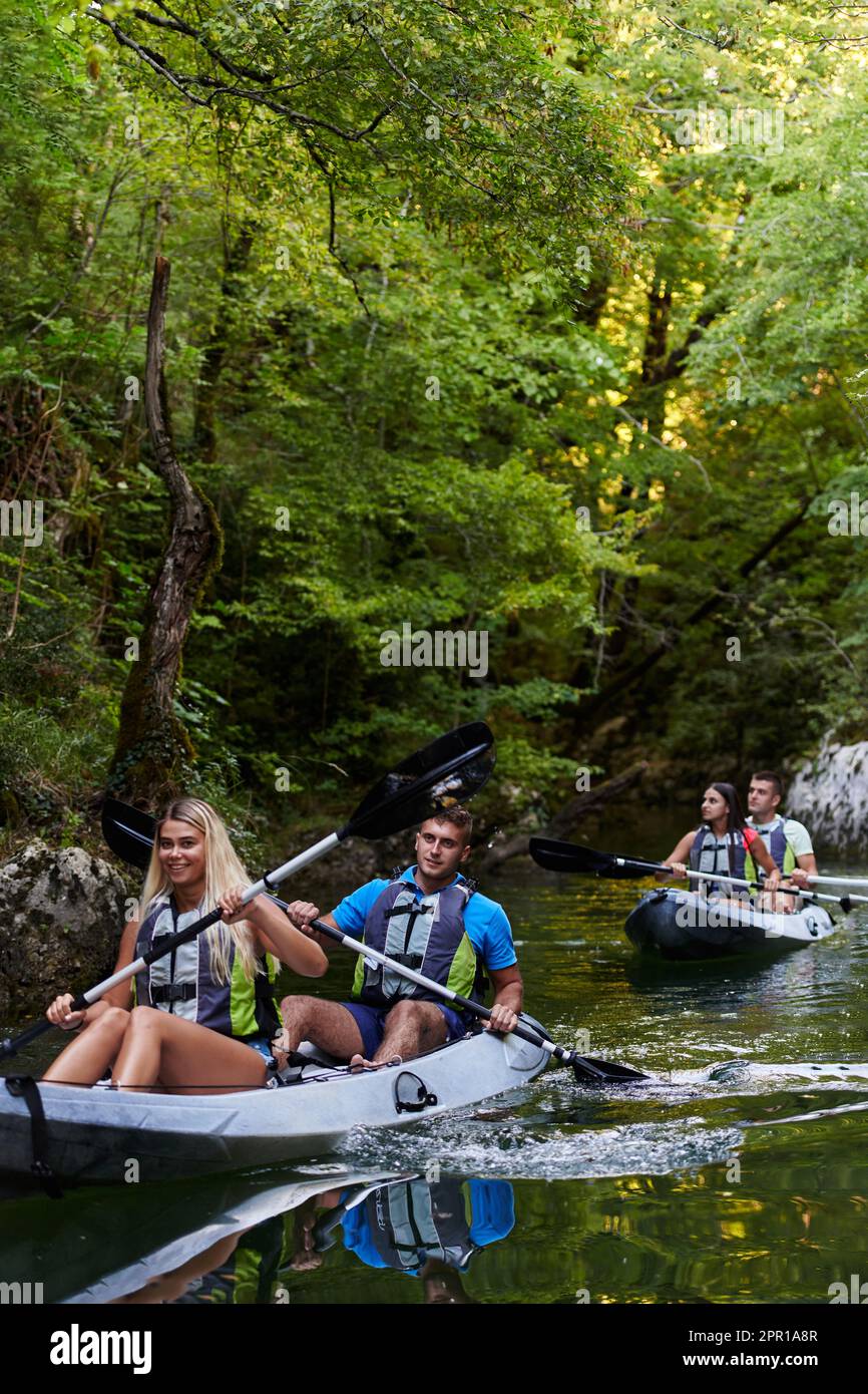 A group of friends enjoying having fun and kayaking while exploring the ...