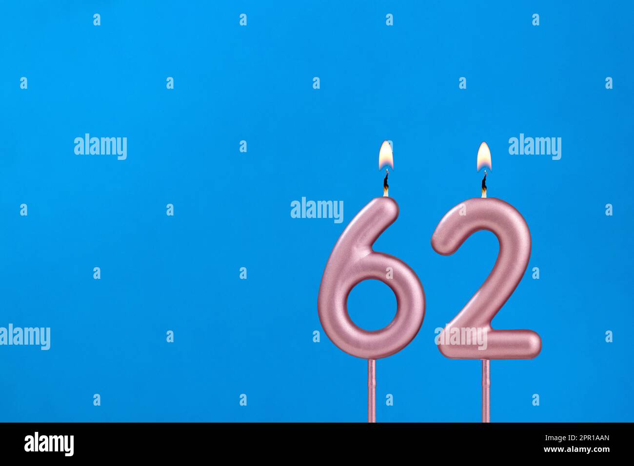 Candle number 62 - Birthday in blues foamy background Stock Photo - Alamy